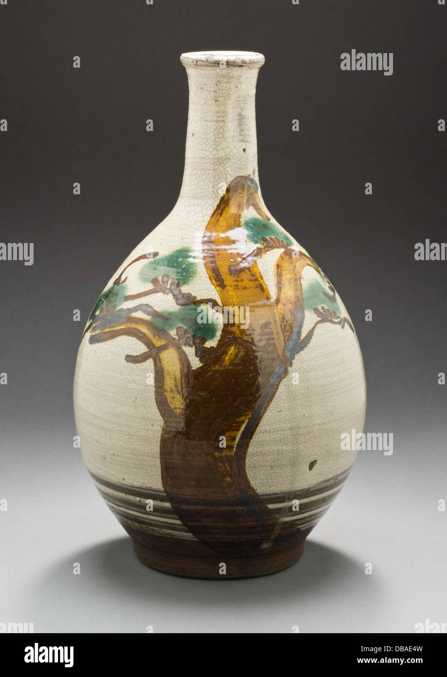 This tokkuri, a traditional Japanese sake bottle, features a delicate ...