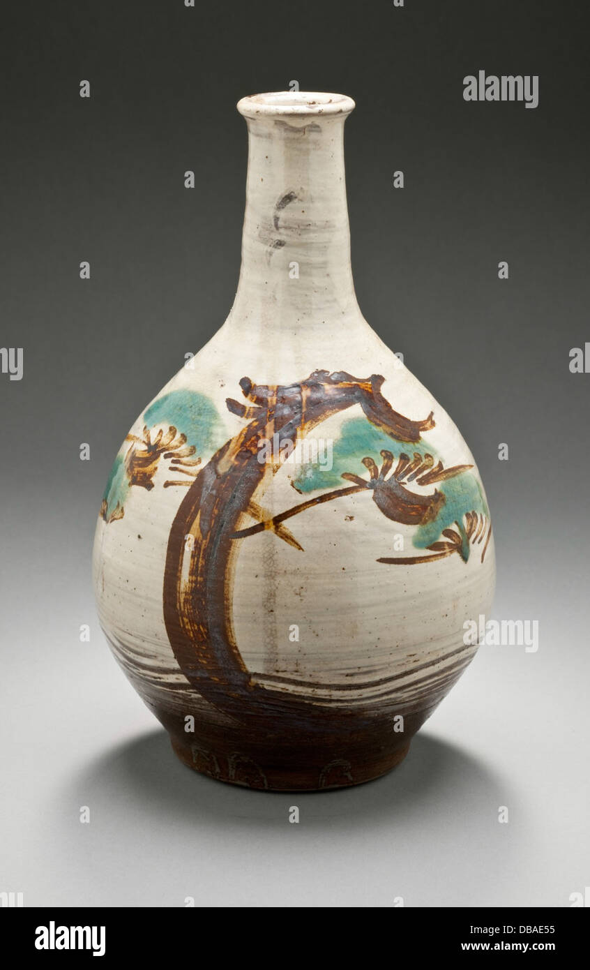 This sake bottle, known as tokkuri, features a pine tree design and ...