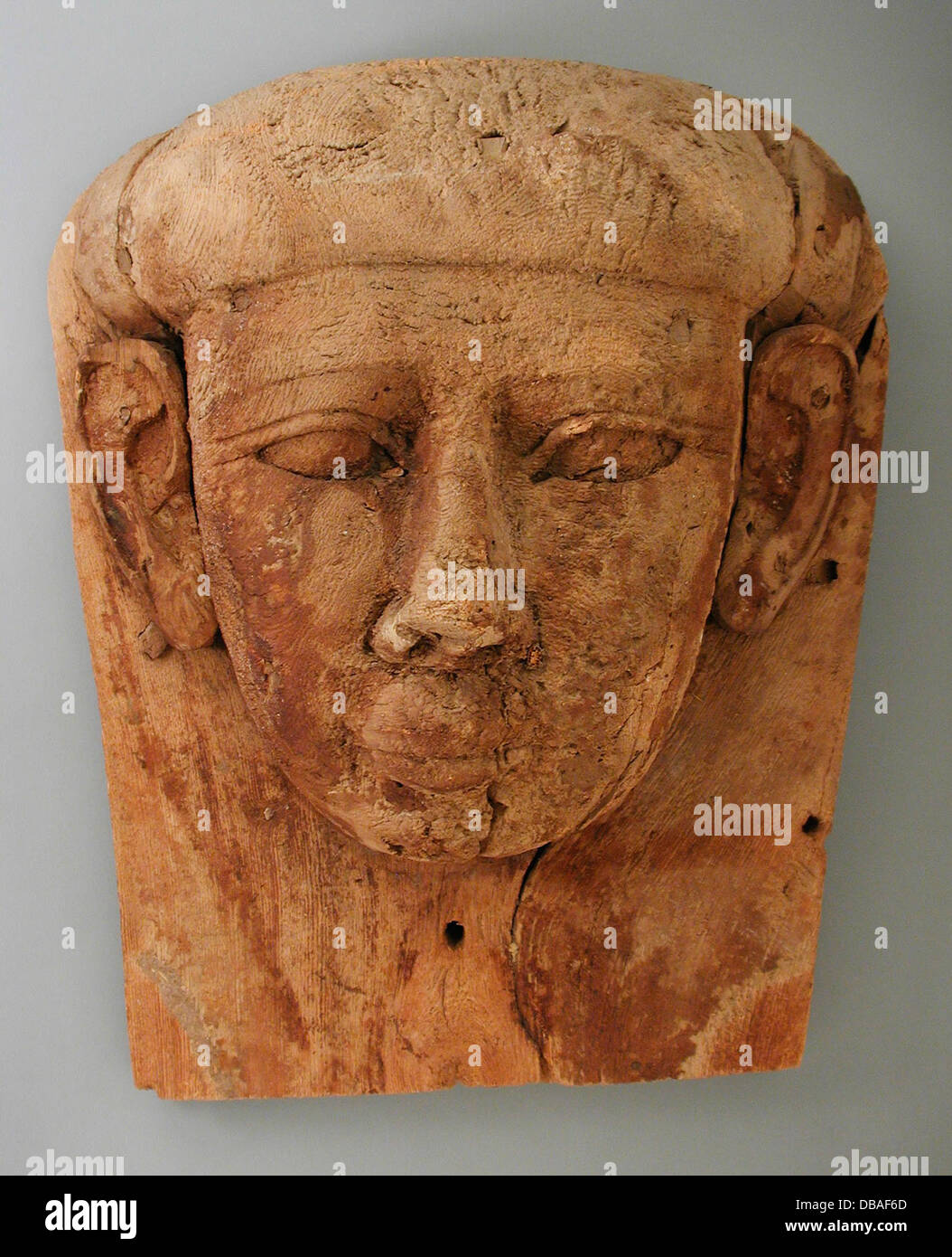 This sarcophagus cover represents the head portion of a burial chest ...