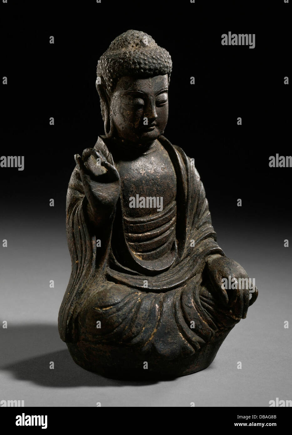 A seated Buddha sculpture, reflecting Buddhist religious art. This ...
