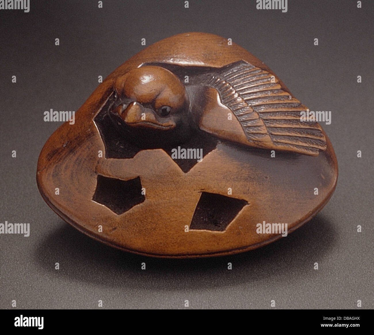 A carved representation of a sea bird within a clamshell, demonstrating ...