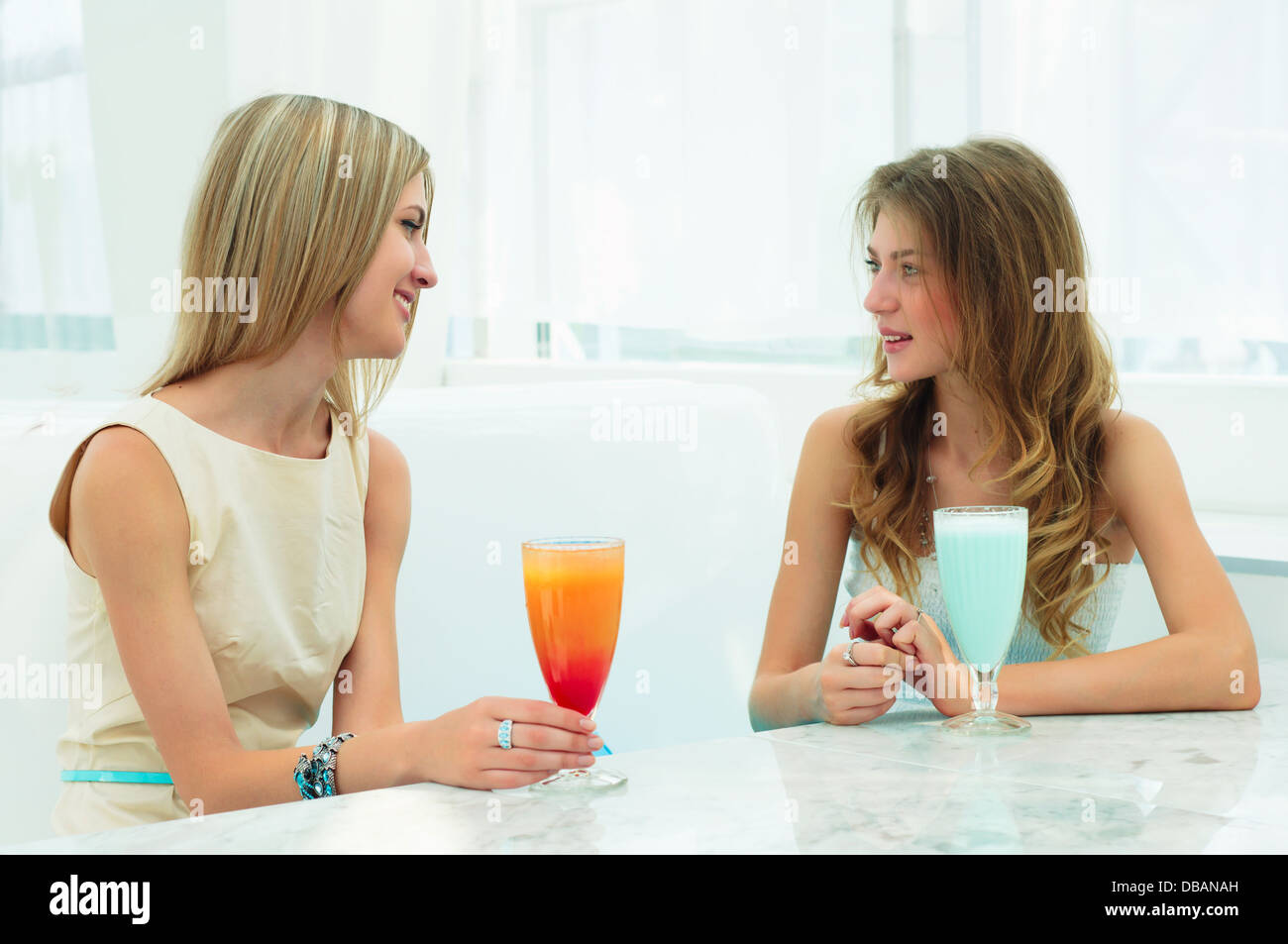 beautiful woman in a cafe talking and drinking beverages Stock Photo ...
