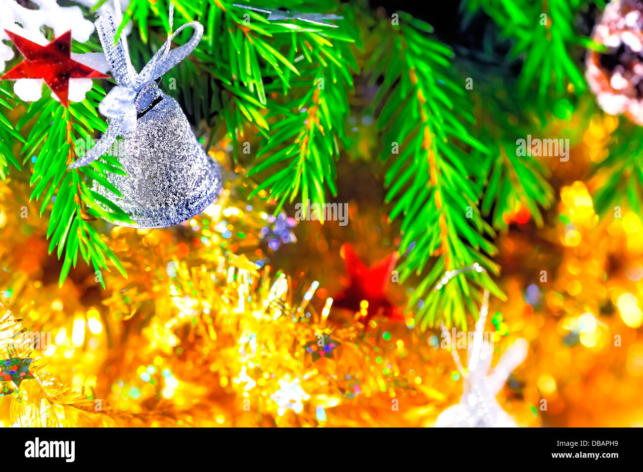Silver bell hanging on the branch of a Christmas tree Stock Photo - Alamy