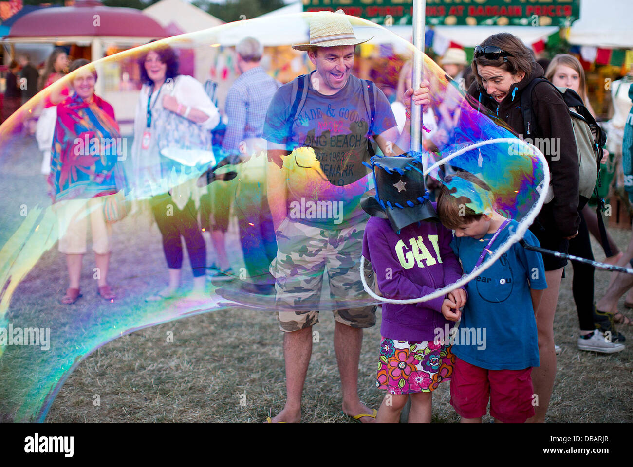 Malmesbury, Wiltshire, UK. 26th July 2013. Samsam Bubbleman passes a ...
