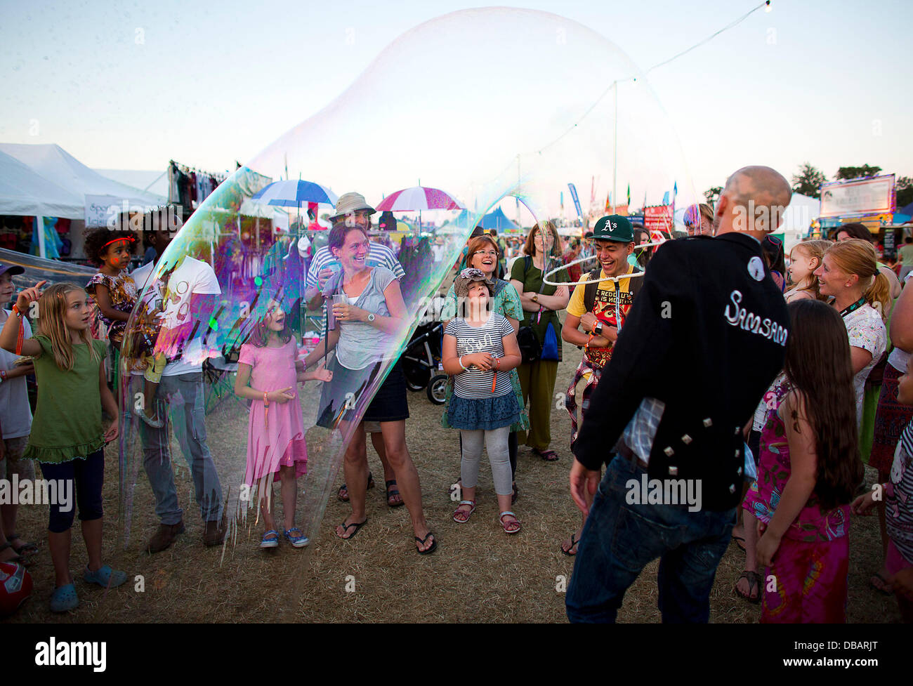 Malmesbury, Wiltshire, UK. 26th July 2013. Samsam Bubbleman passes a ...