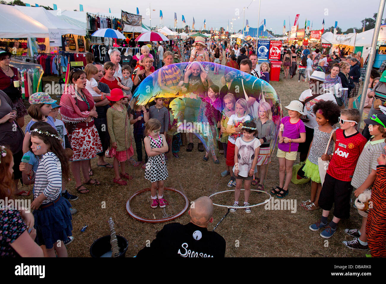 Malmesbury, Wiltshire, UK. 26th July 2013. Samsam Bubbleman passes a ...