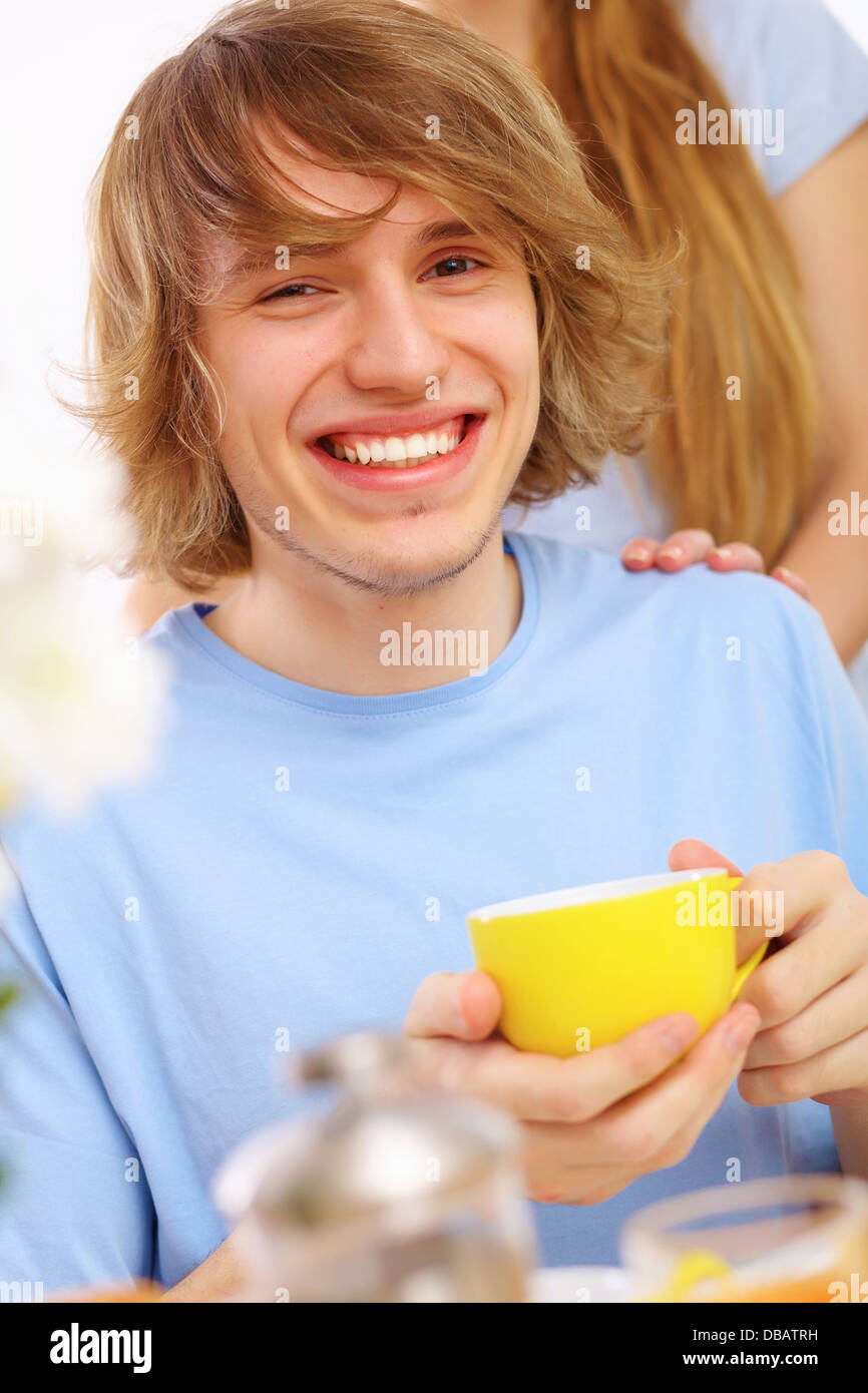 Young happy man drinking tea Stock Photo - Alamy