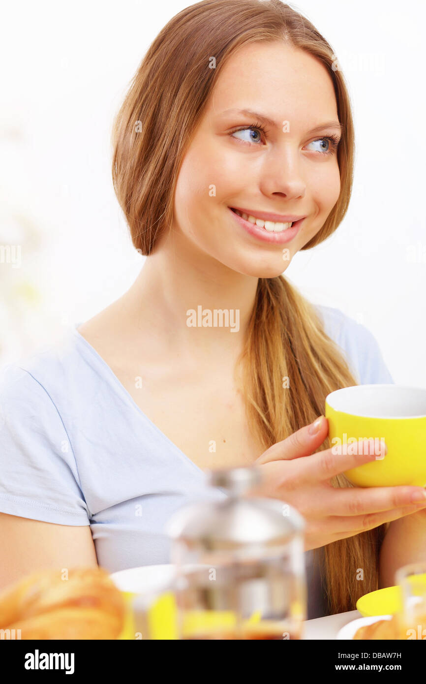 Beautiful young woman drinking tea Stock Photo - Alamy