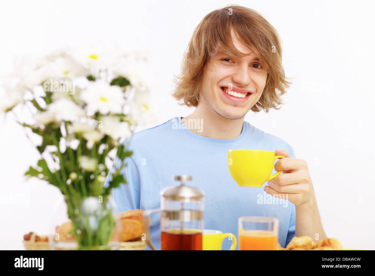 Young happy man drinking tea Stock Photo - Alamy