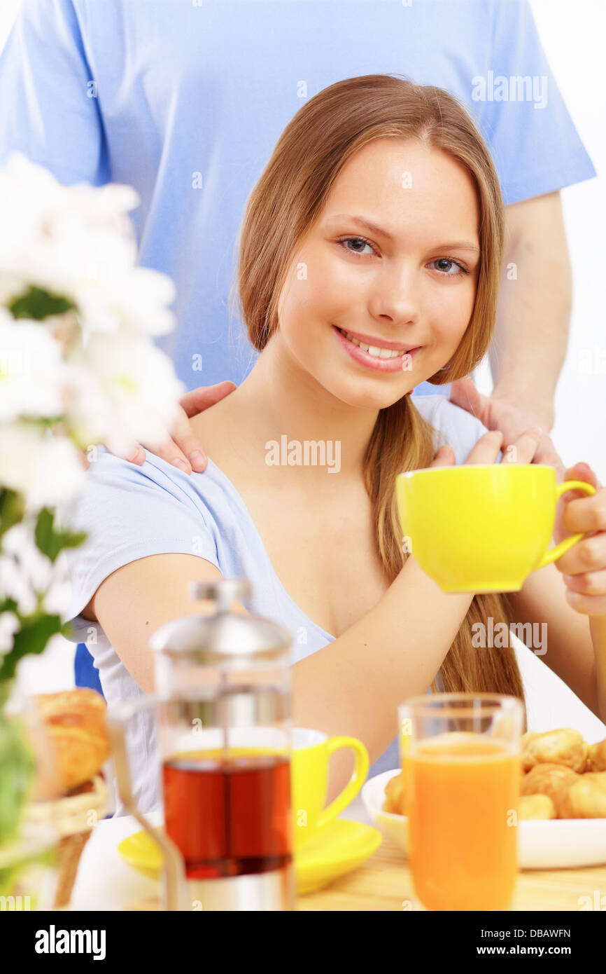 Beautiful young woman drinking tea Stock Photo - Alamy