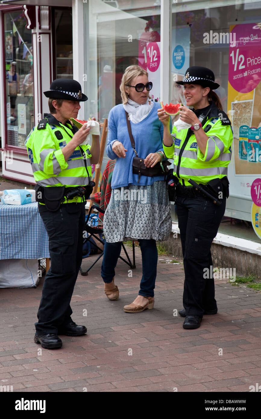 Two Female British Police Officers Eating Watermelon and Chatting To ...