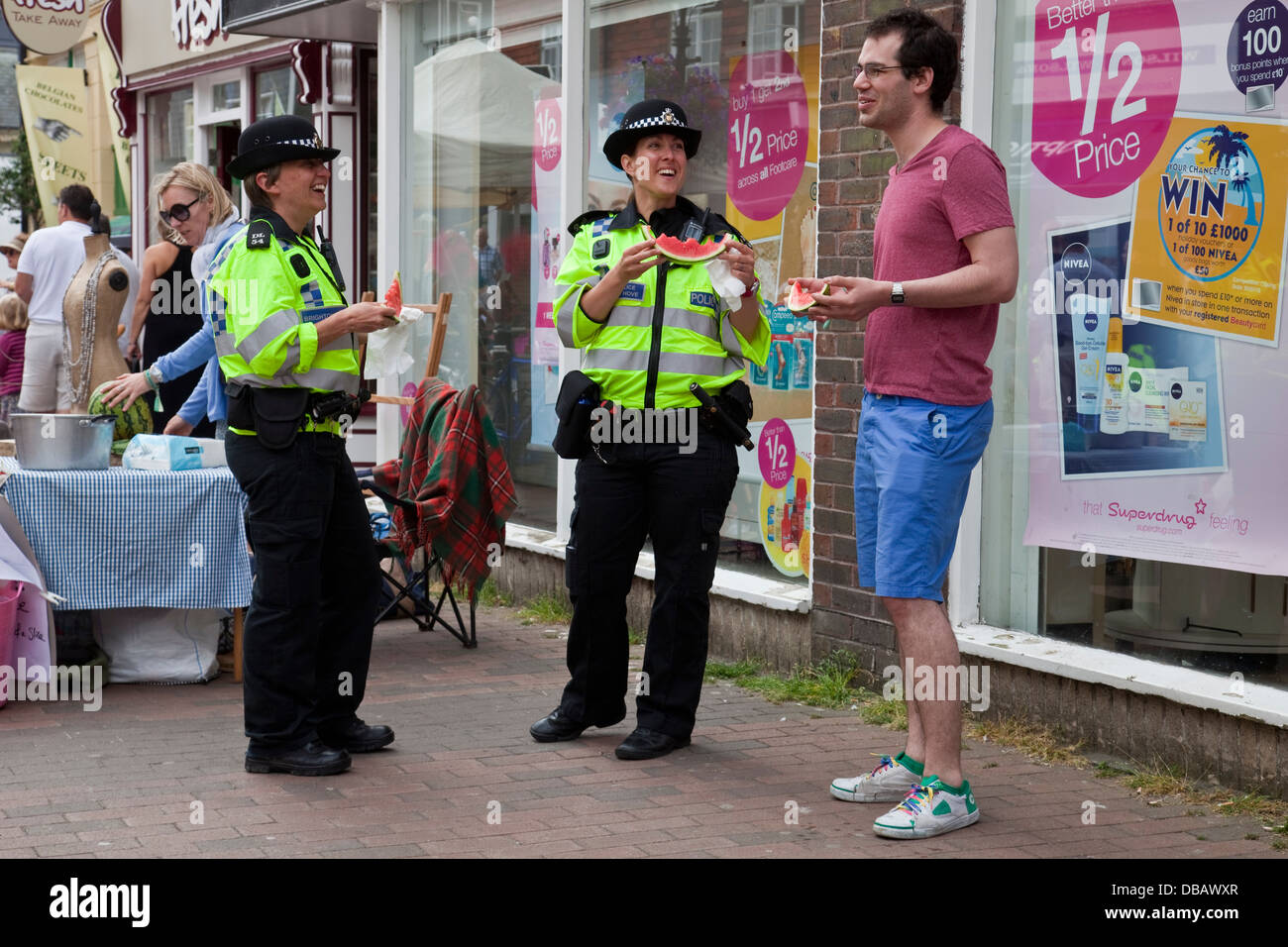 Two Female British Police Officers Eating Watermelon and Chatting To ...