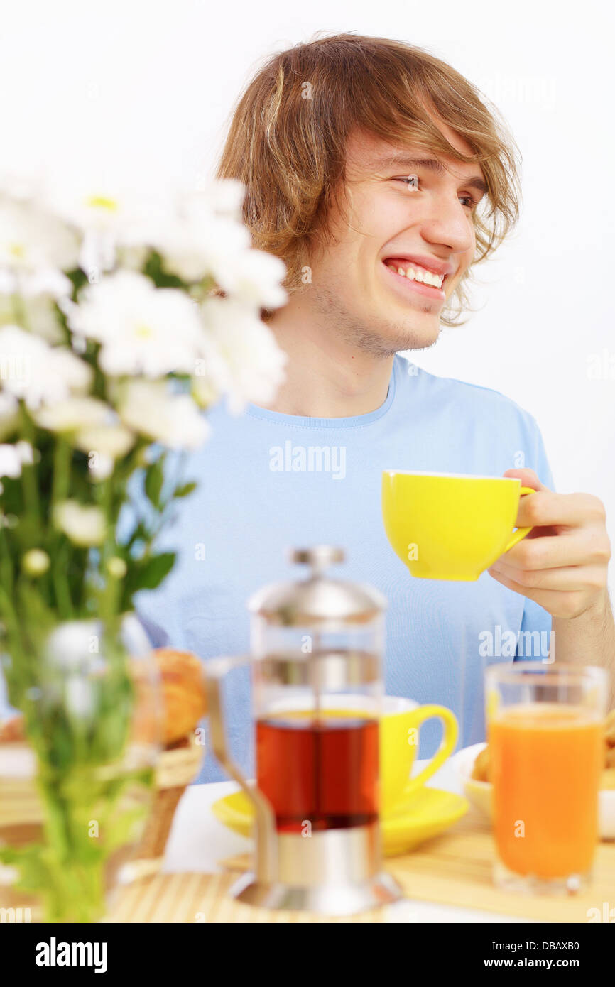 Young happy man drinking tea Stock Photo - Alamy