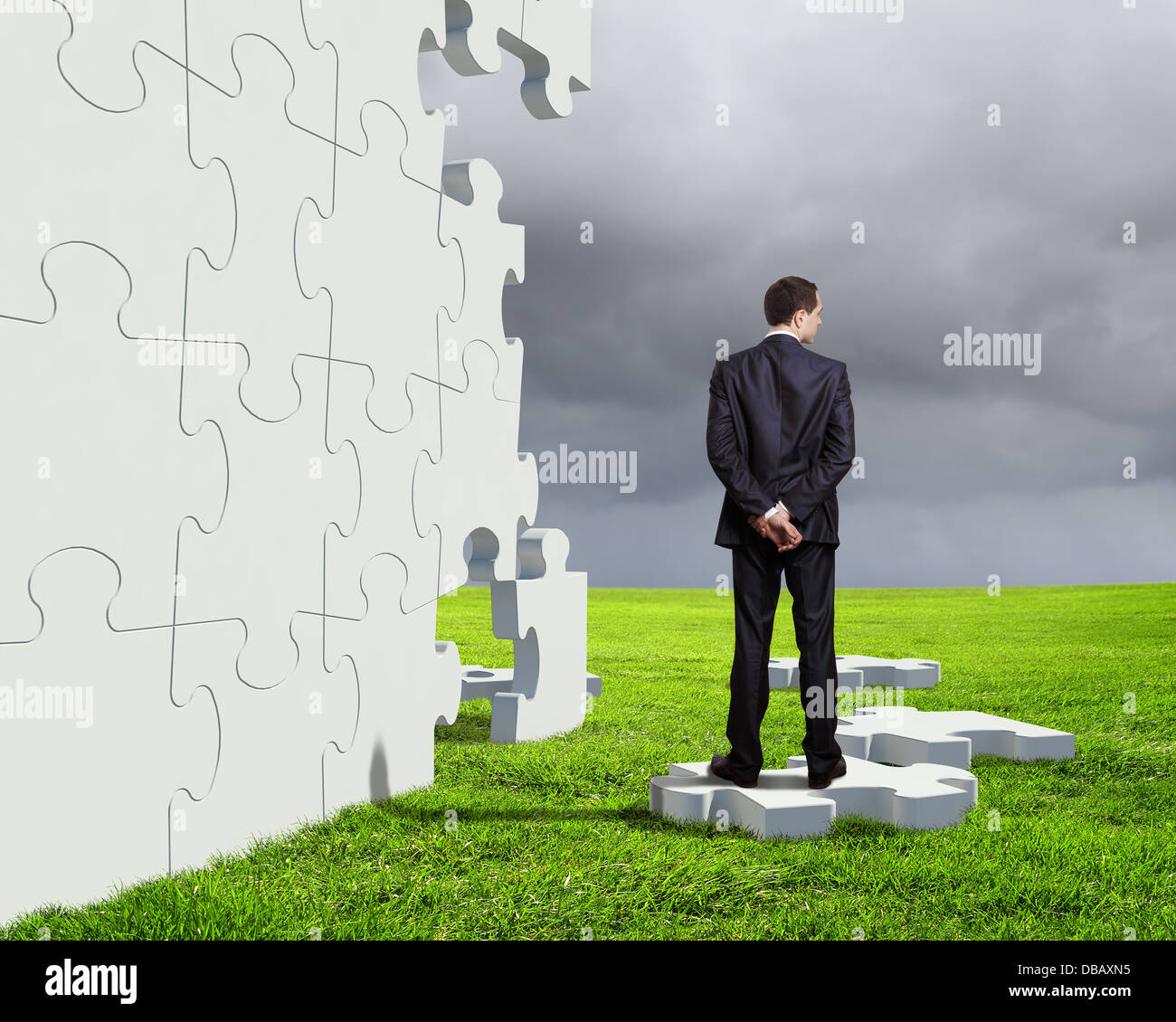 Businessman with a puzzle pieces Stock Photo - Alamy