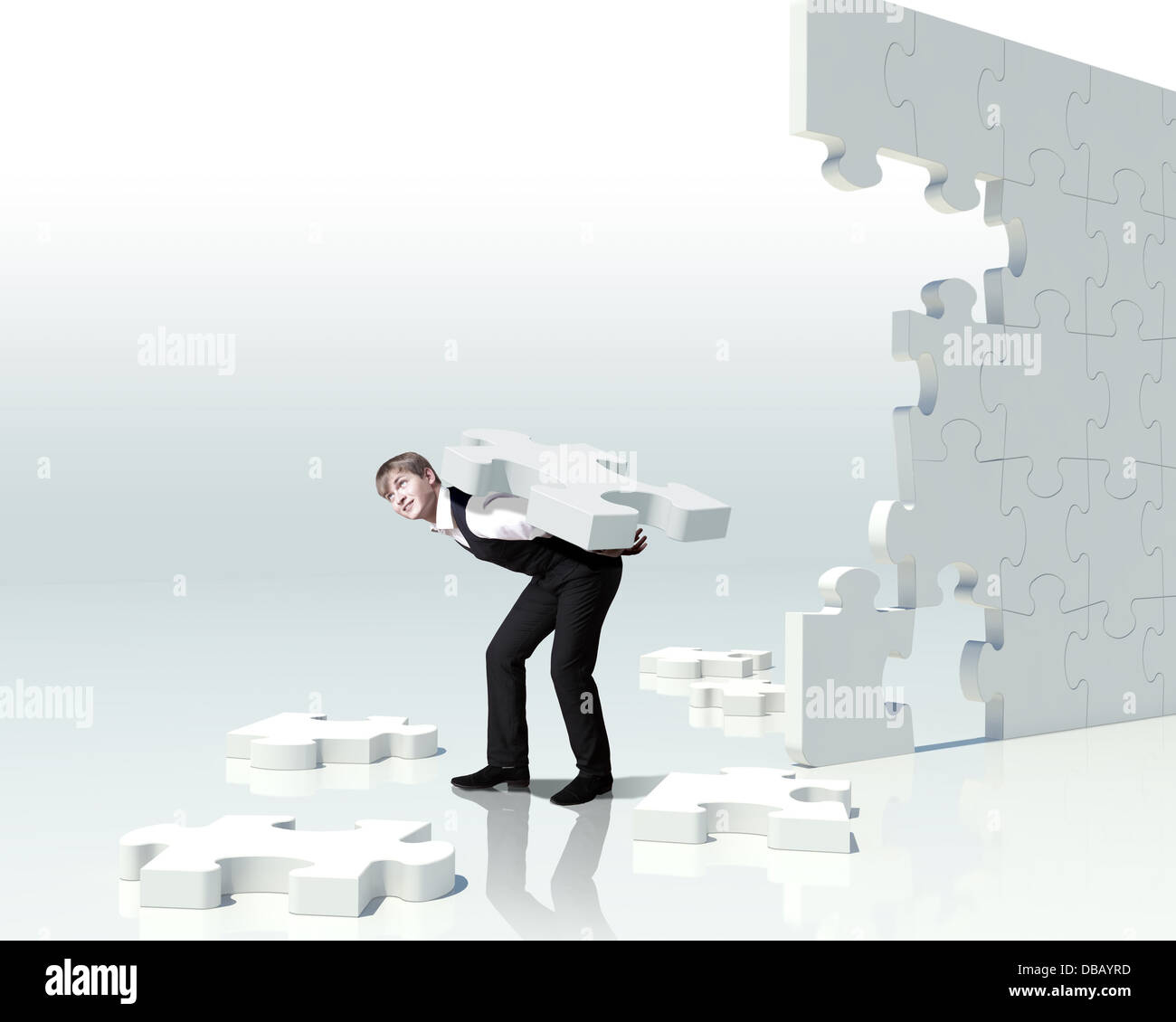 Businessman with a puzzle pieces Stock Photo - Alamy