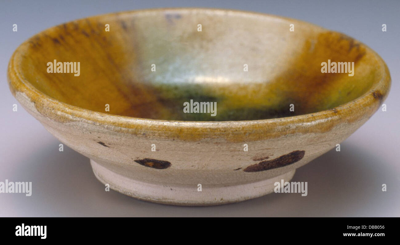 This small bowl, crafted from ceramic, demonstrates ancient design ...