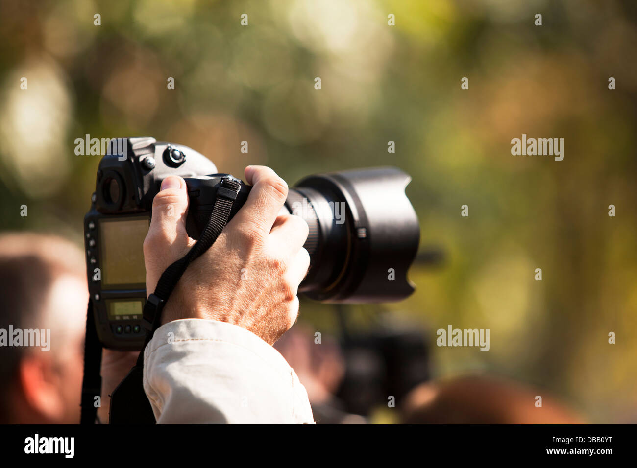 photographer holding camera Stock Photo - Alamy