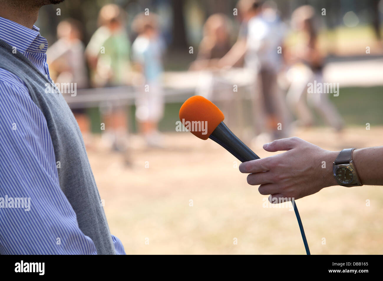 A journalist is making an interview with a microphone Stock Photo - Alamy