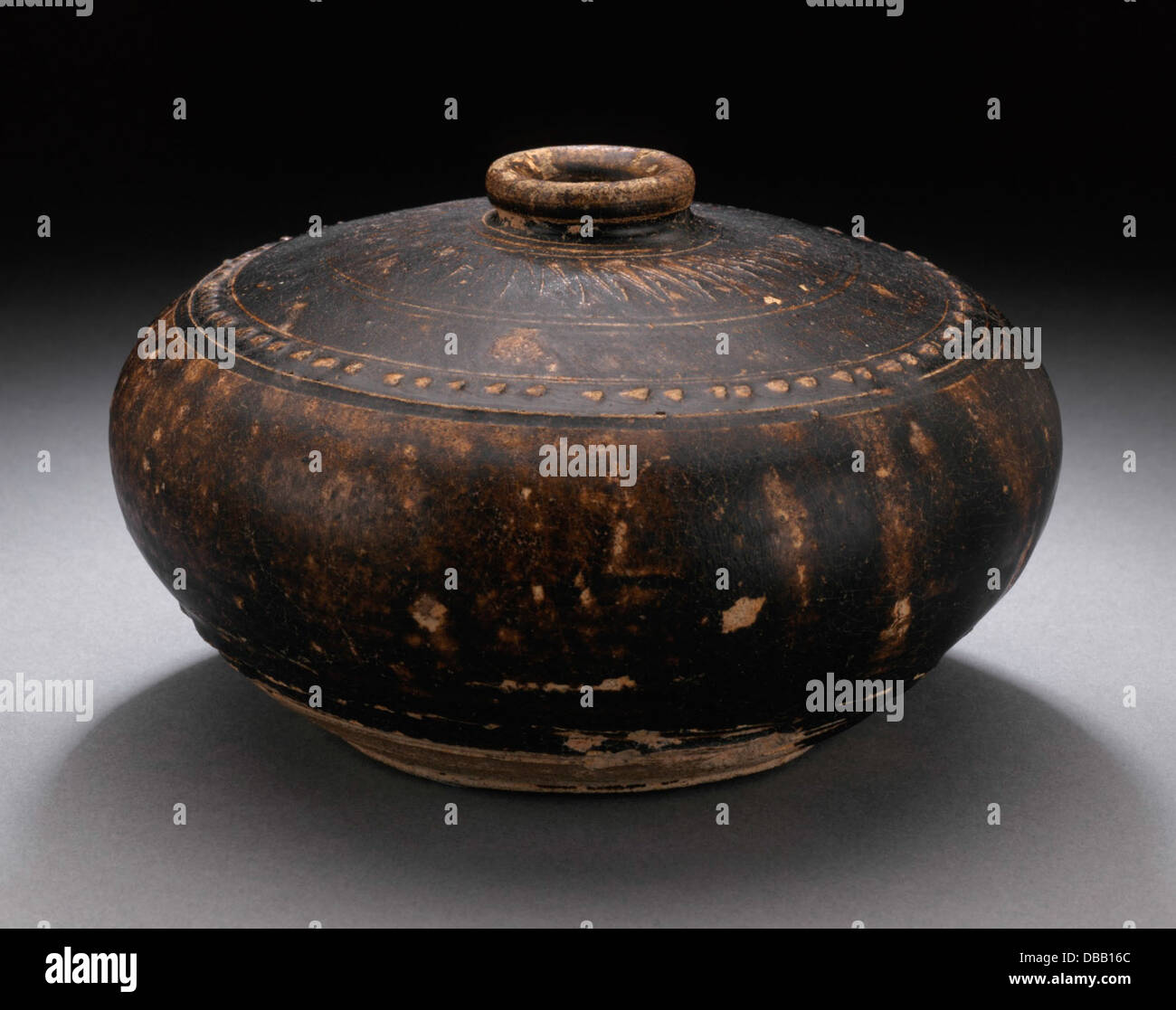 This squat jar is adorned with dots, a common decorative feature in ...