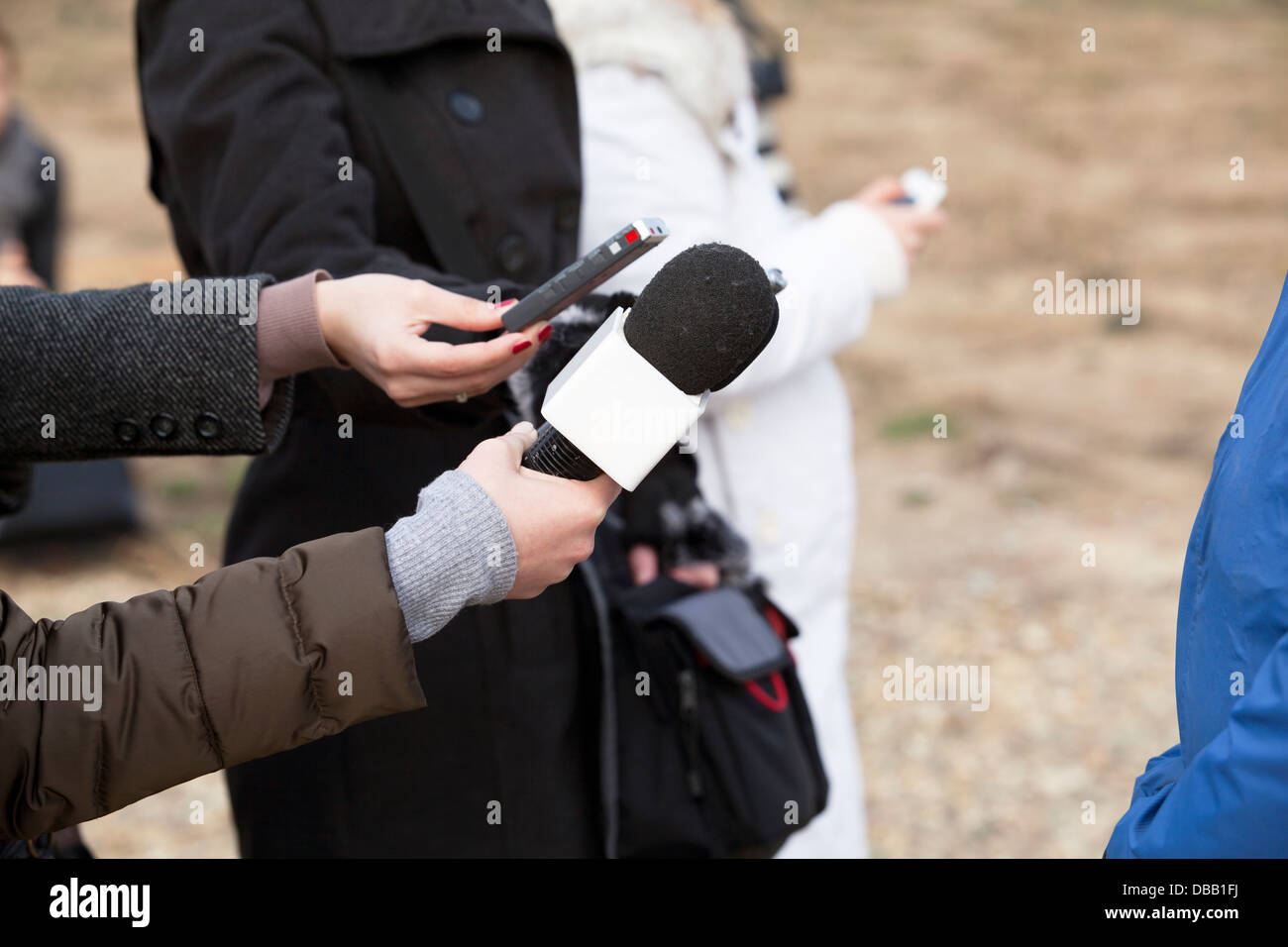 A journalist is making a interview with a microphone Stock Photo - Alamy