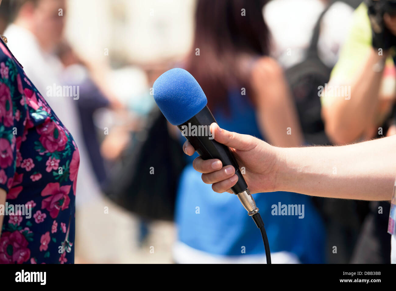 A journalist is making an interview with a microphone Stock Photo - Alamy