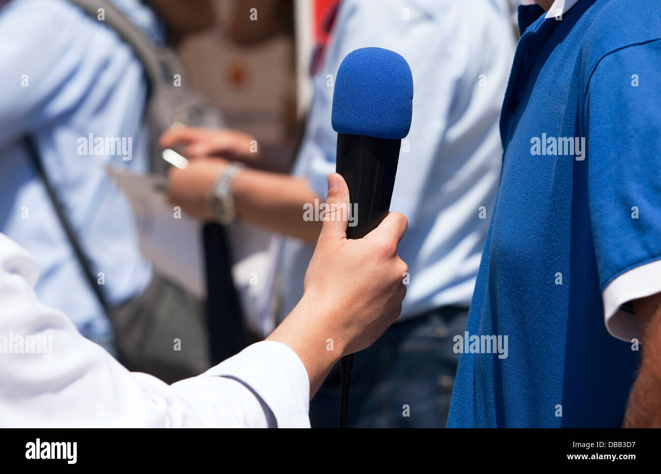 A journalist is making an interview with a microphone Stock Photo - Alamy