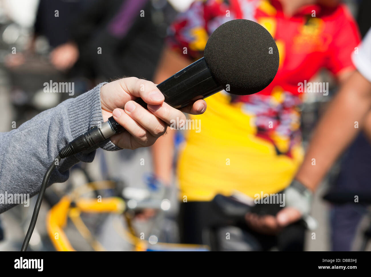 A journalist is making a interview with a microphone Stock Photo - Alamy