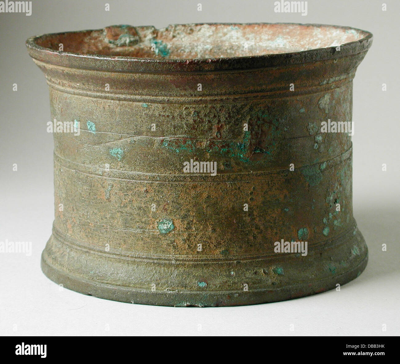 This cylindrical vessel features a flared rim and is crafted from ...