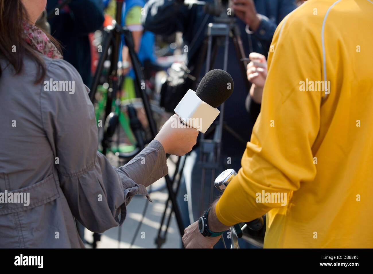 A journalist is making an interview with a microphone Stock Photo - Alamy