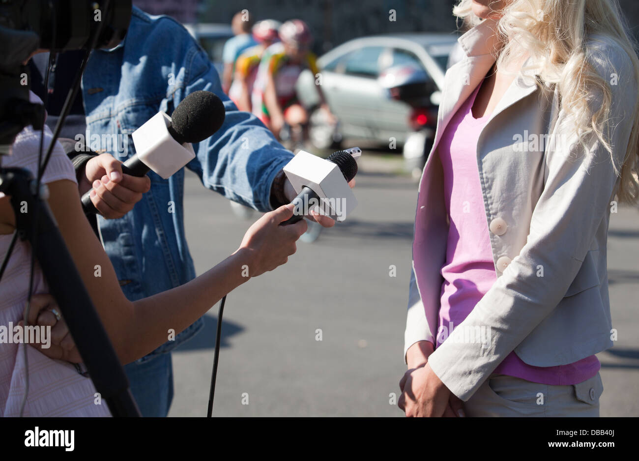 A journalist is making an interview with a microphone Stock Photo - Alamy