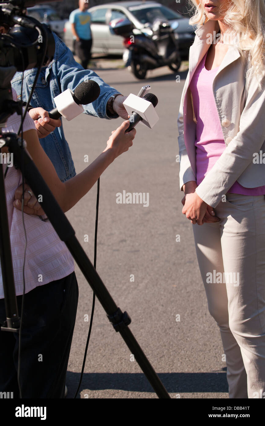 A journalist is making an interview with a microphone Stock Photo - Alamy