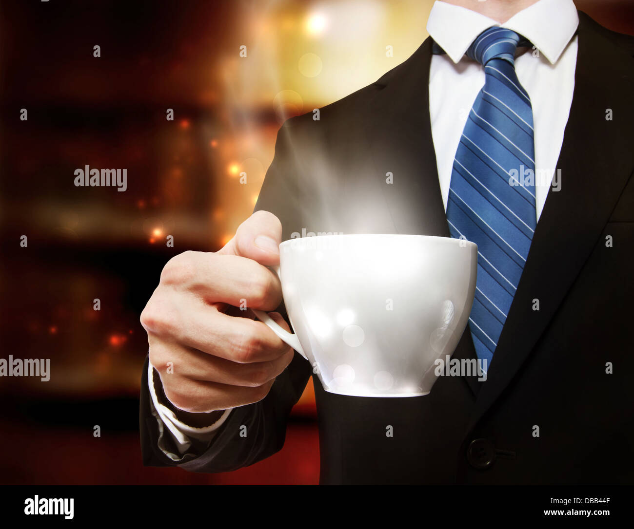 Business man holding a steaming cup of hot coffee Stock Photo - Alamy