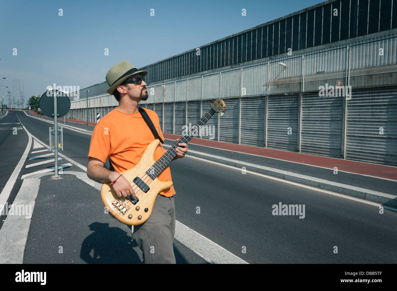 Young musician playing bass guitar in the street Stock Photo - Alamy
