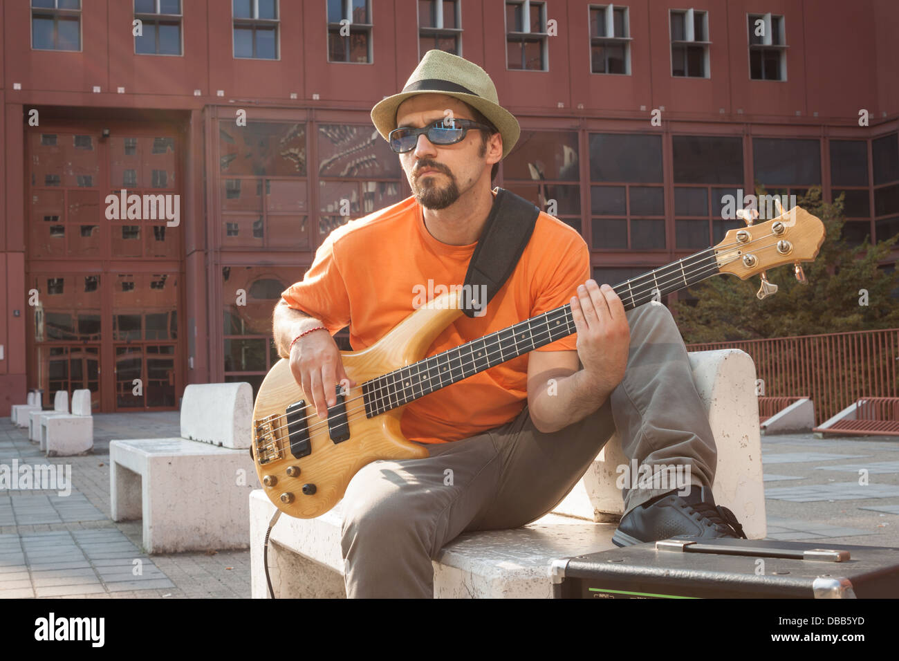 Young musician playing bass guitar in the street Stock Photo - Alamy