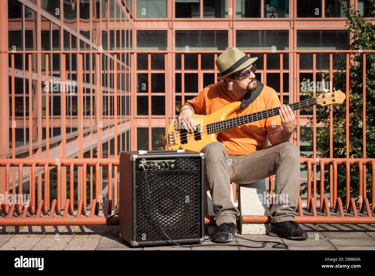 Young musician playing bass guitar in the street Stock Photo - Alamy