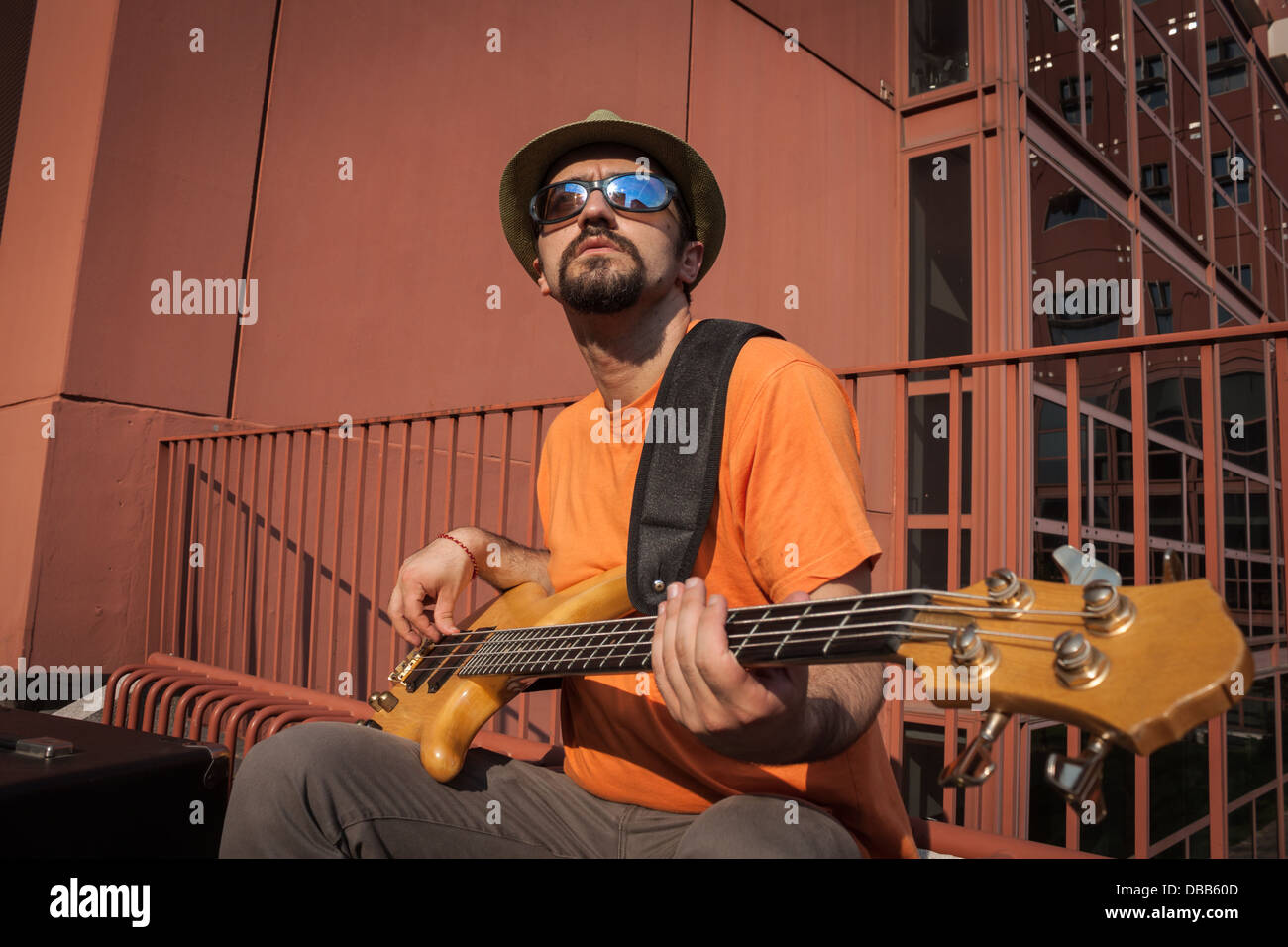 Young musician playing bass guitar in the street Stock Photo - Alamy