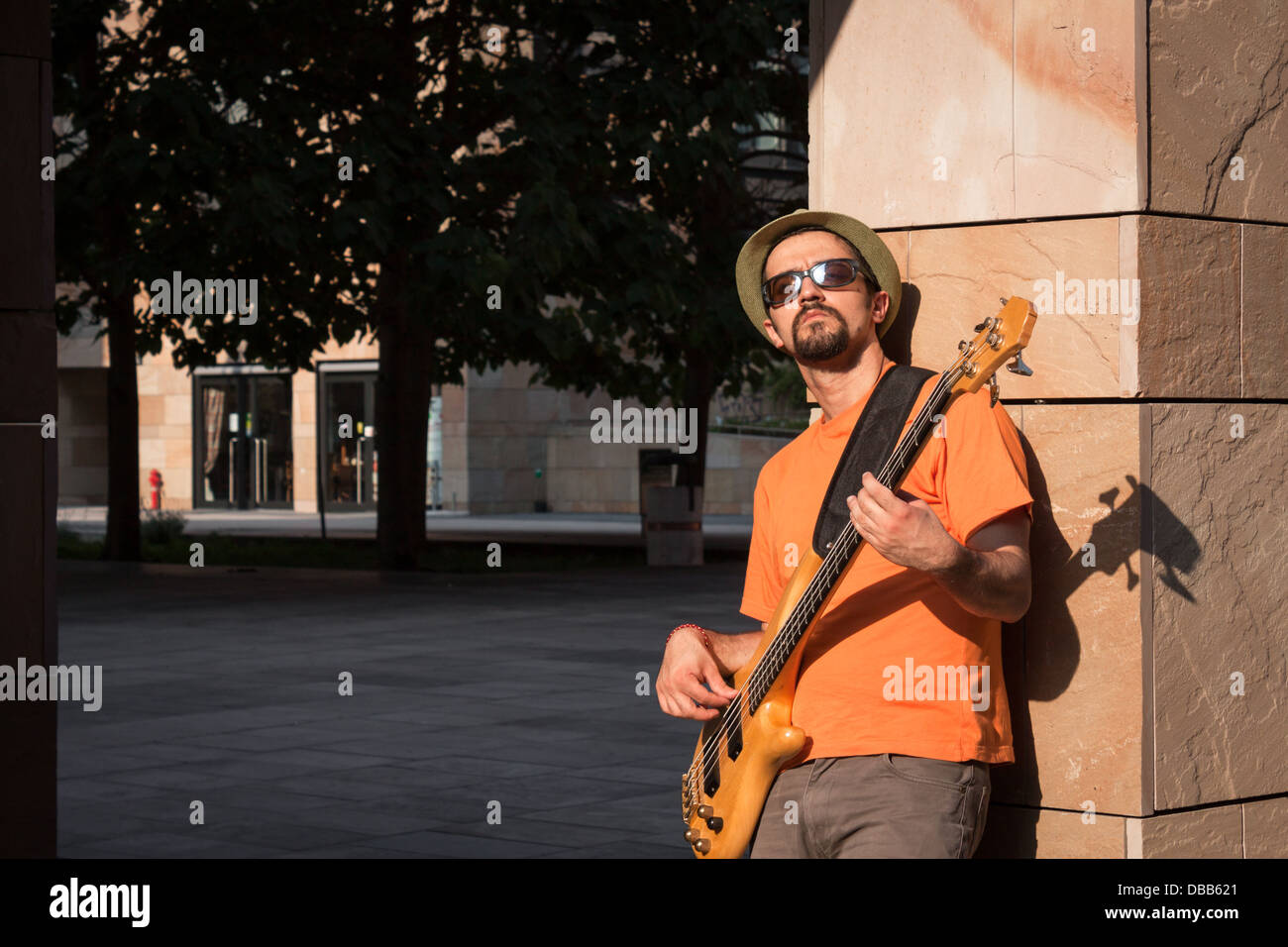 Young musician playing bass guitar in the street Stock Photo - Alamy