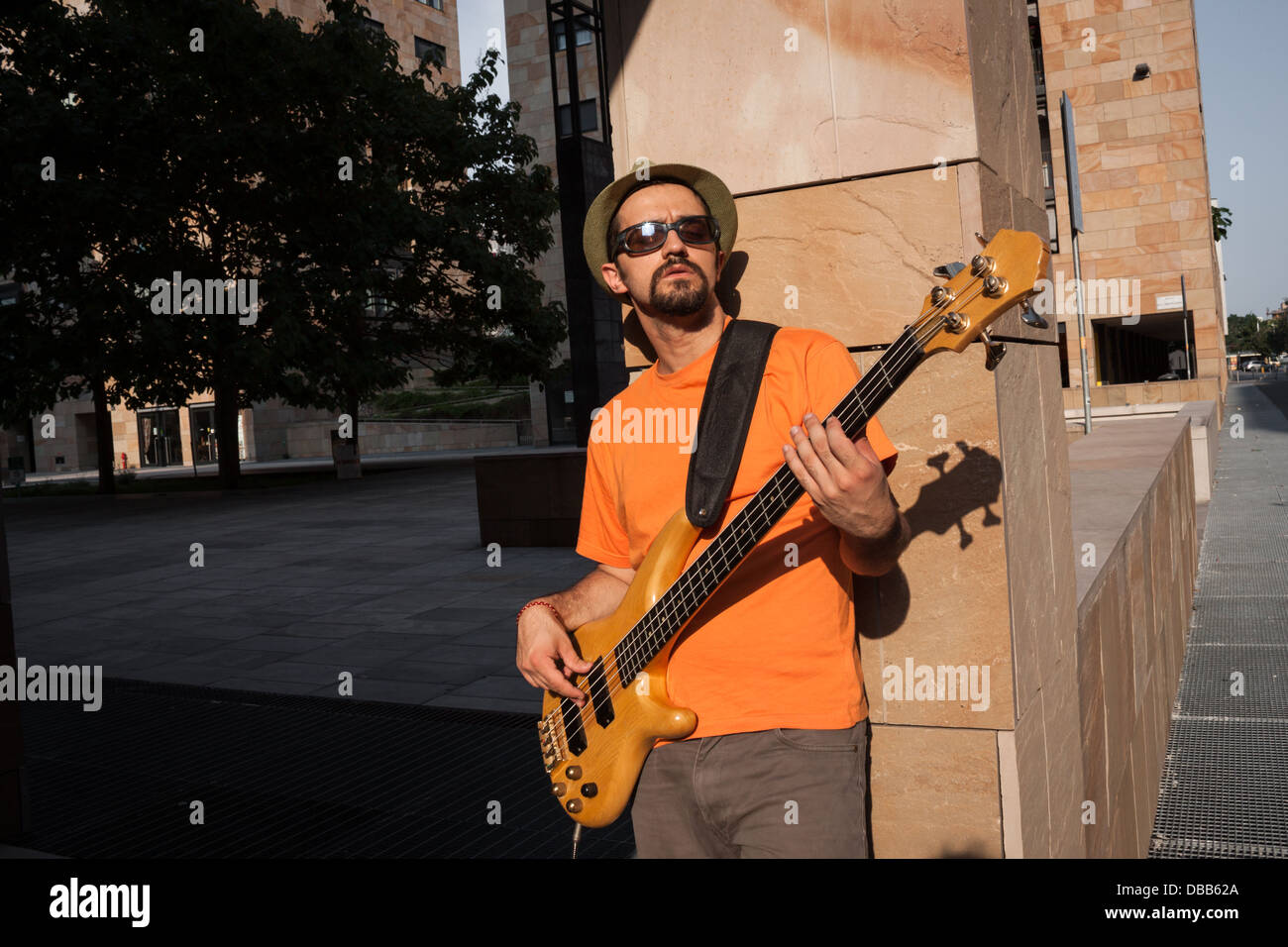 Young man bassist playing guitar hi-res stock photography and images ...