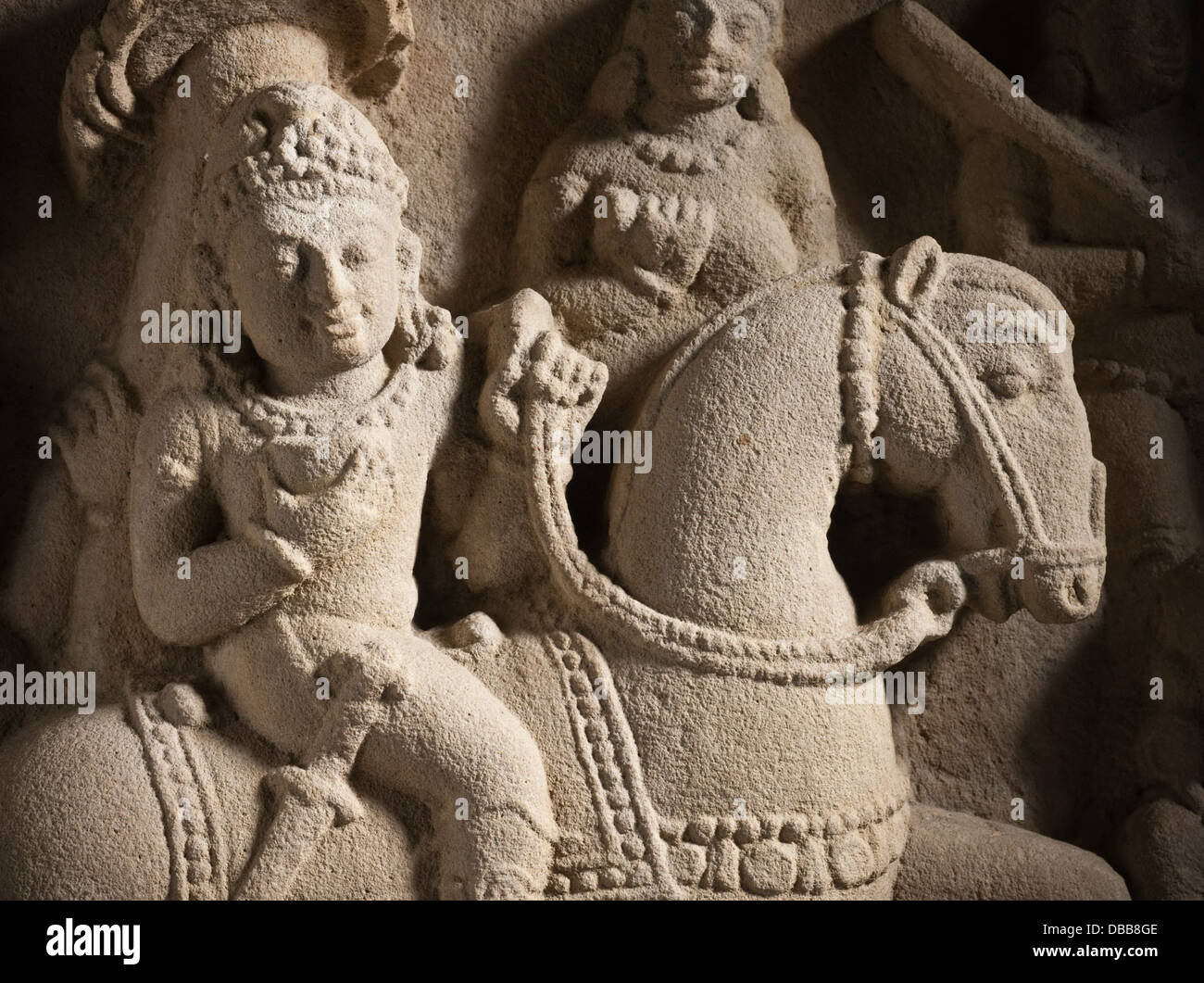 This sculpture depicts the Hindu god Revanta accompanied by his ...