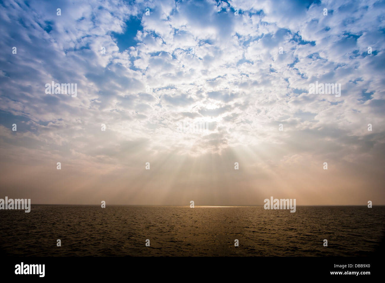 Sunbeam through the haze on the sky over the sea: can be used as ...