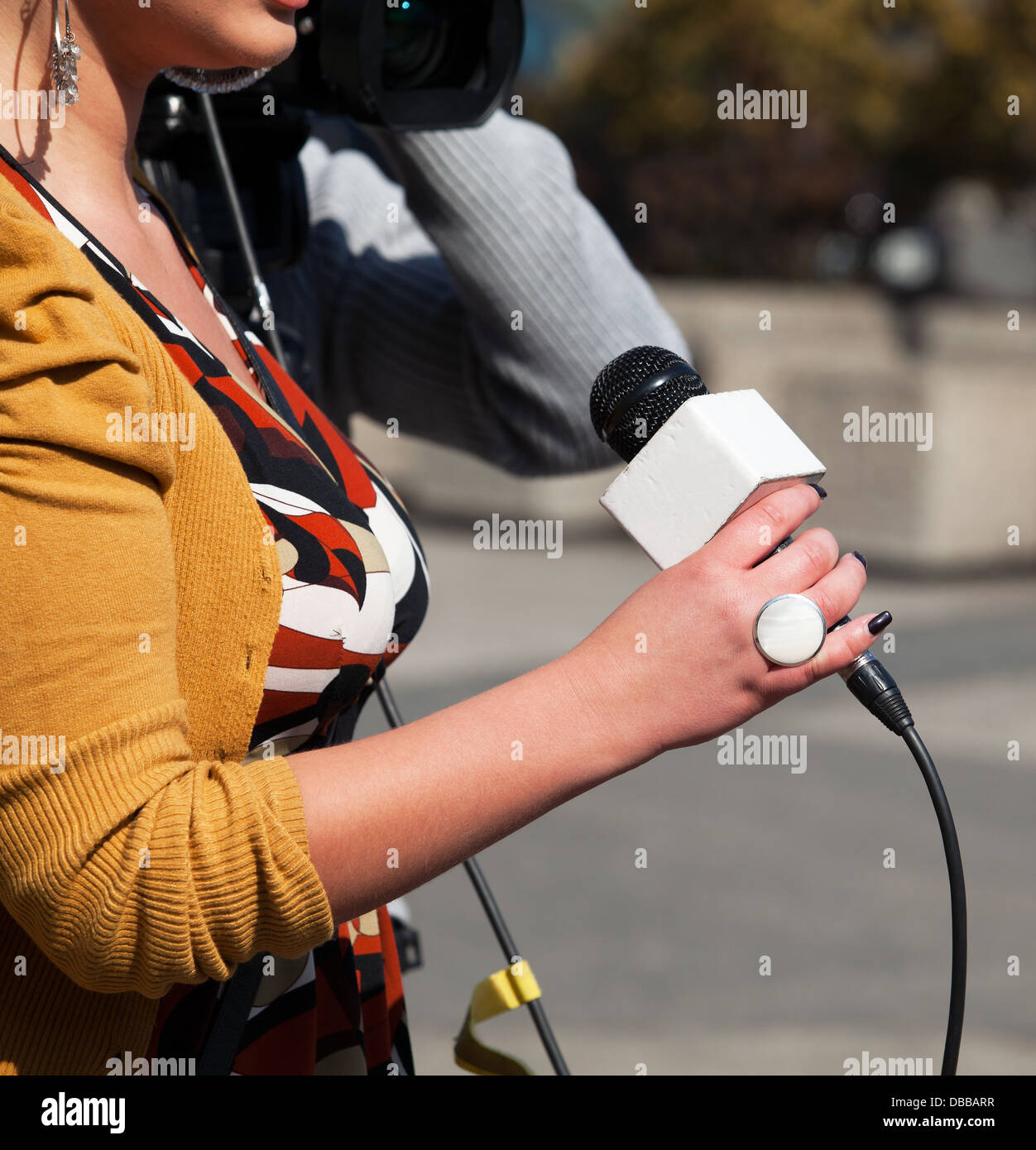 A journalist is making an interview with a microphone Stock Photo - Alamy