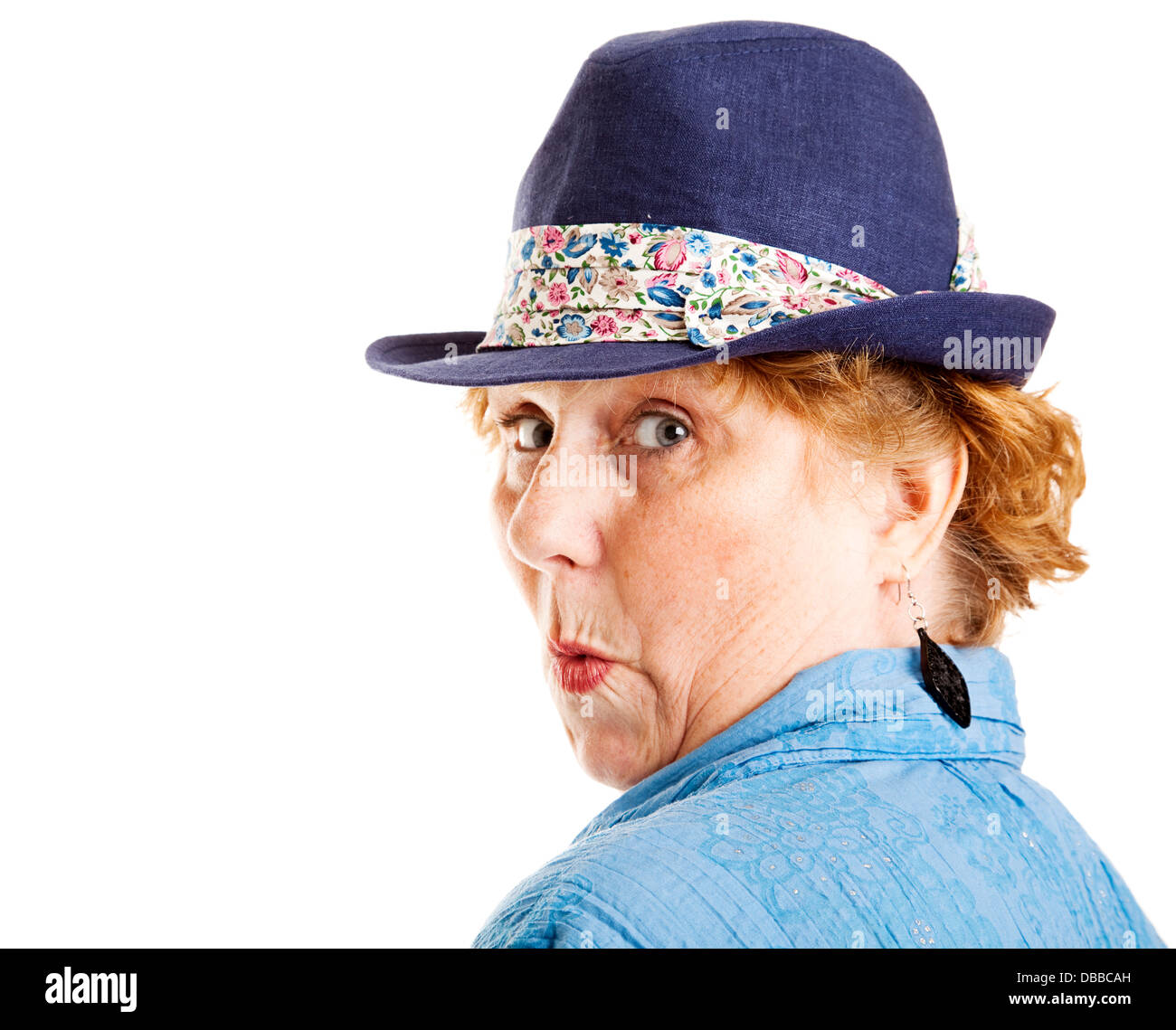 Mature woman looking over her shoulder with a surprised expression ...