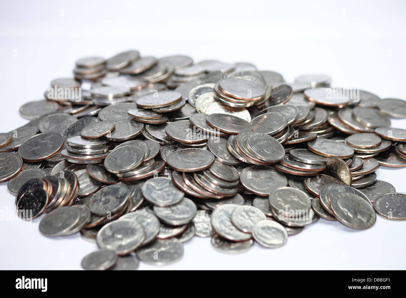Silver Coins Spilled on a white Table Stock Photo - Alamy