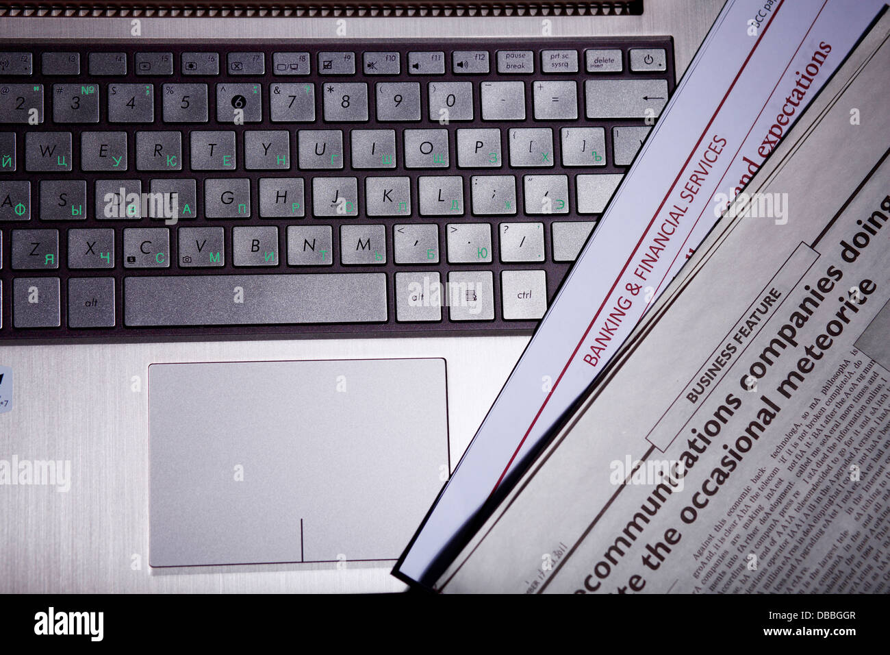 Notebook keyboard with a newspaper Stock Photo - Alamy