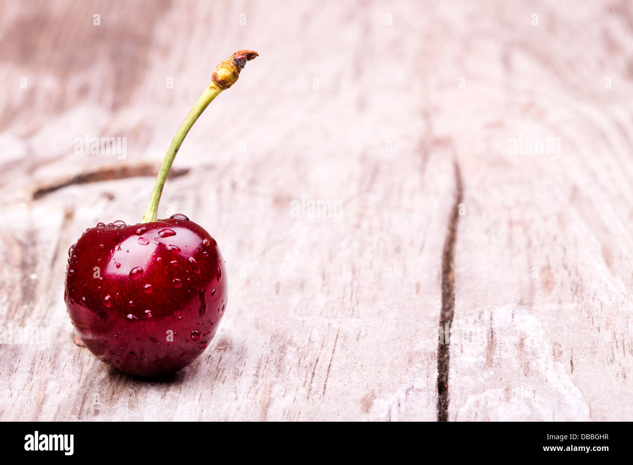 Cherries on wooden table with water drops macro background Stock Photo ...