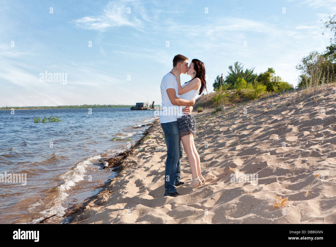 couple kissing on beach Stock Photo - Alamy
