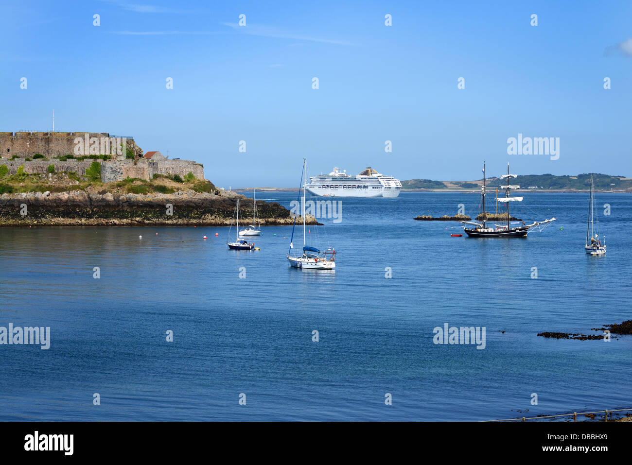 Boats in Havelet Bay overlooked by Castle Cornet and a cruise ship in ...