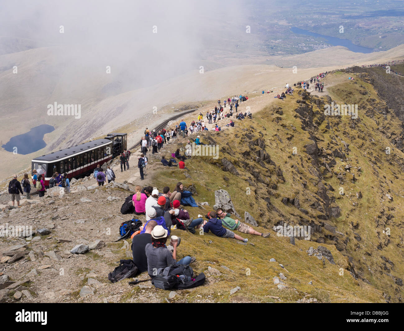 Lots of people by railway on Mt Snowdon summit on a busy summer weekend ...