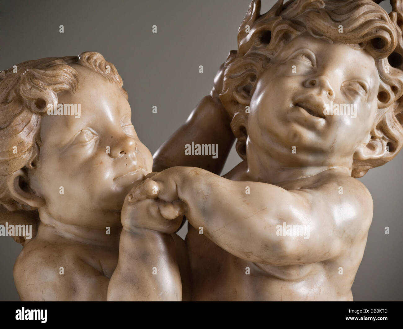 This sculpture depicts a winged female figure crowning a putto with a ...