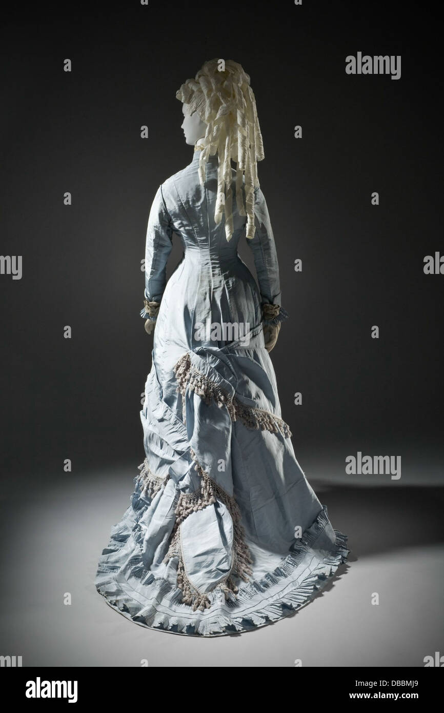 This woman's dress is an example of historical fashion, reflecting the ...